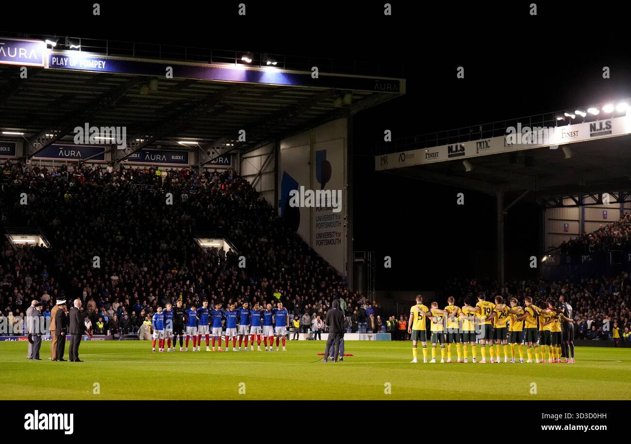 Players from both teams in the centre circle as they observe a moment ...