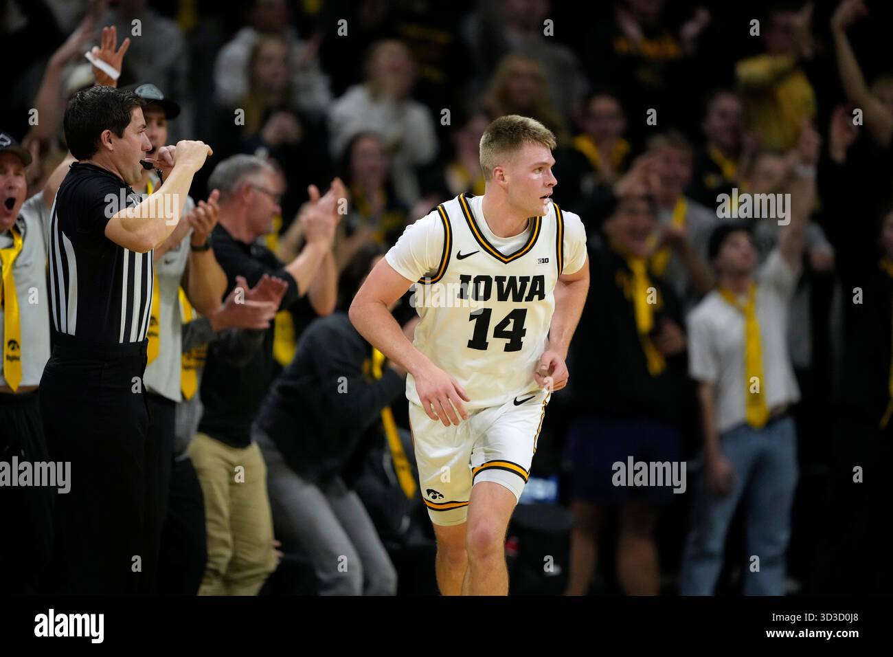 Iowa guard Bennett Stirtz runs up court after making a three-point ...