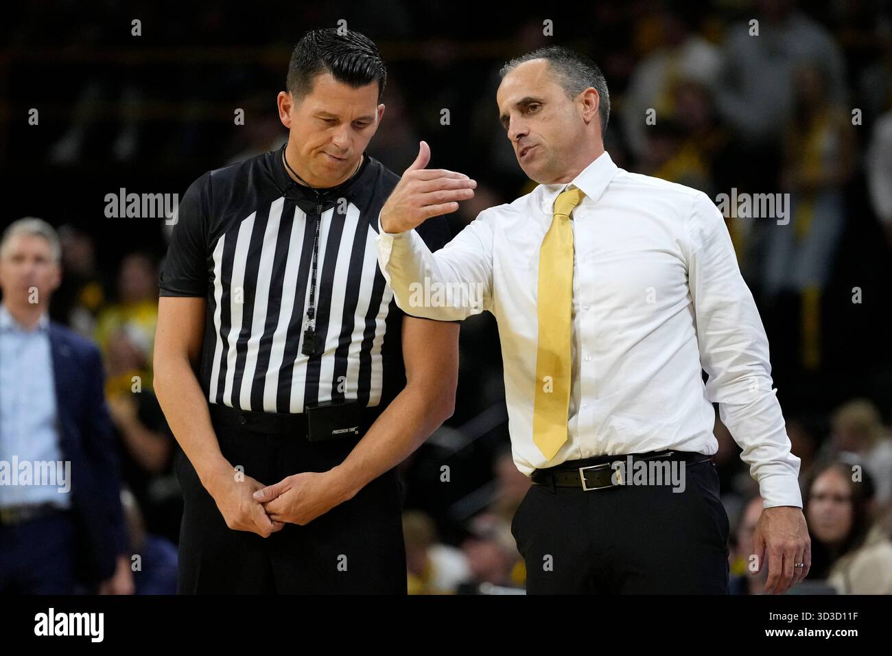 Iowa head coach Ben McCollum, right, talks with an official during the ...
