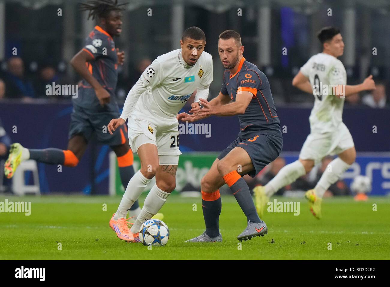 Kairat's Edmilson, left, challenges for the ball with Inter Milan's ...