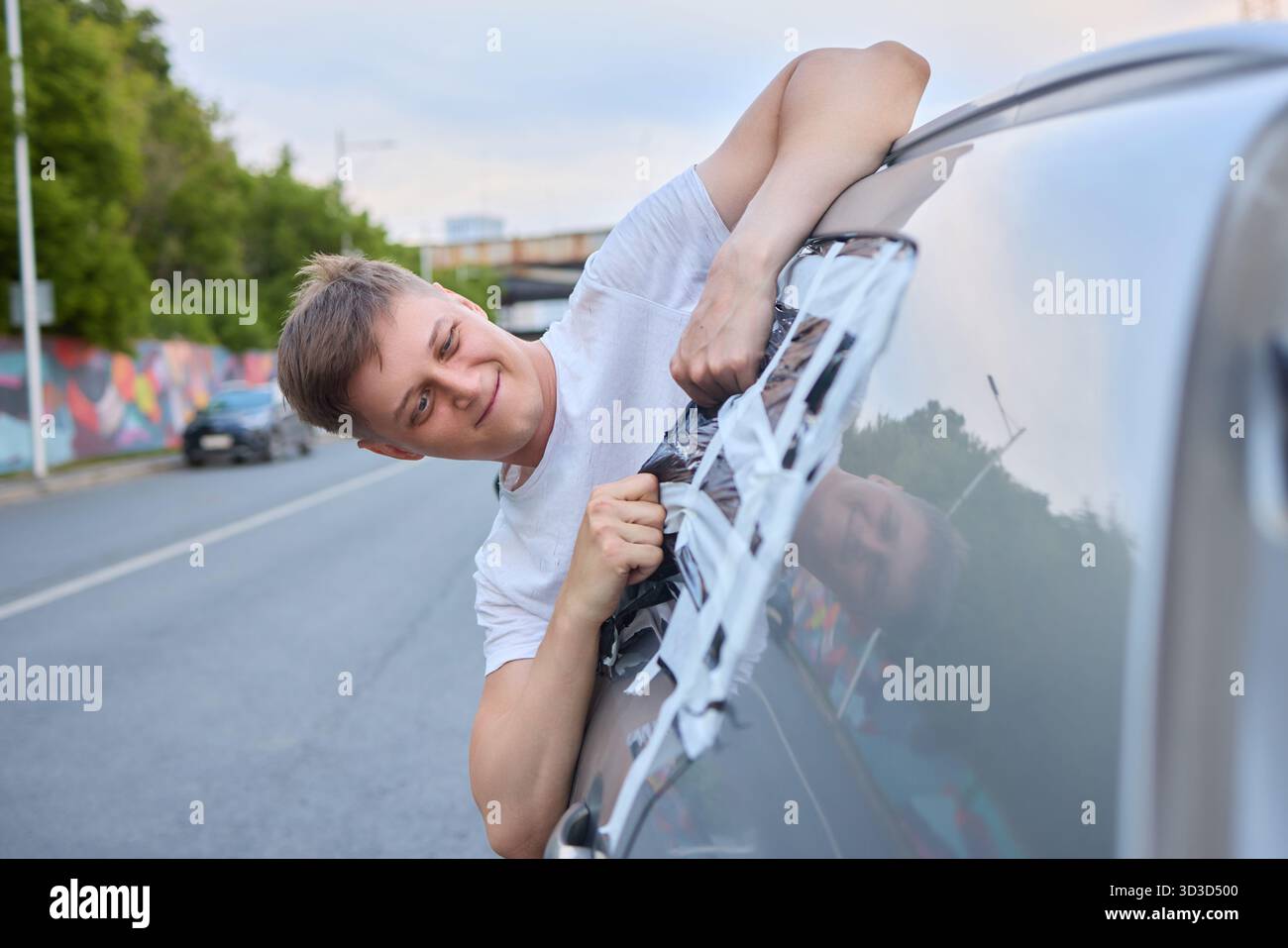 In an emergency, cover broken car window with duct tape for a quick ...