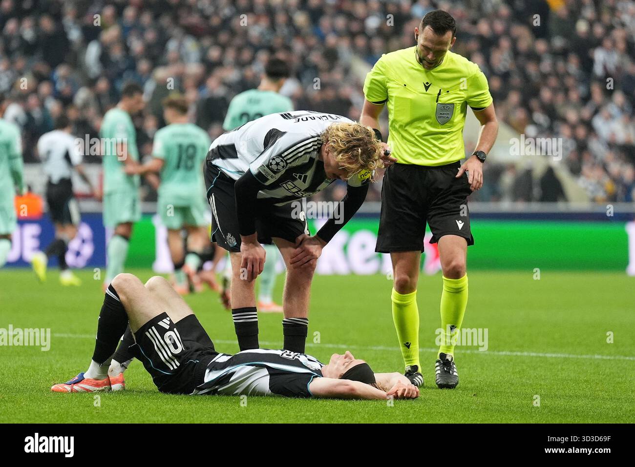 Newcastle United's Anthony Gordon is checked on by Nick Woltemade after ...