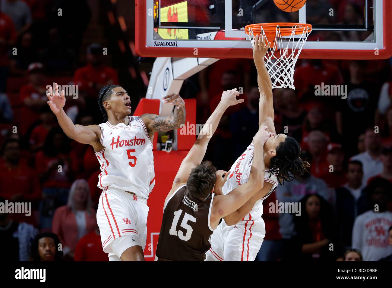 Houston guard Isiah Harwell, right, is fouled on a shot attempt by ...