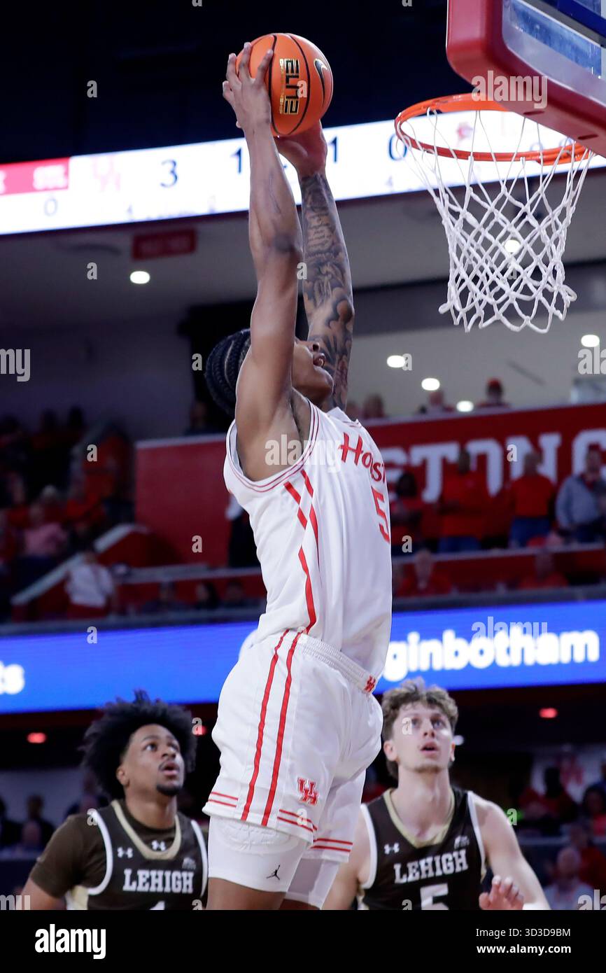 Houston center Chris Cenac Jr., center, dunks the ball over Lehigh ...