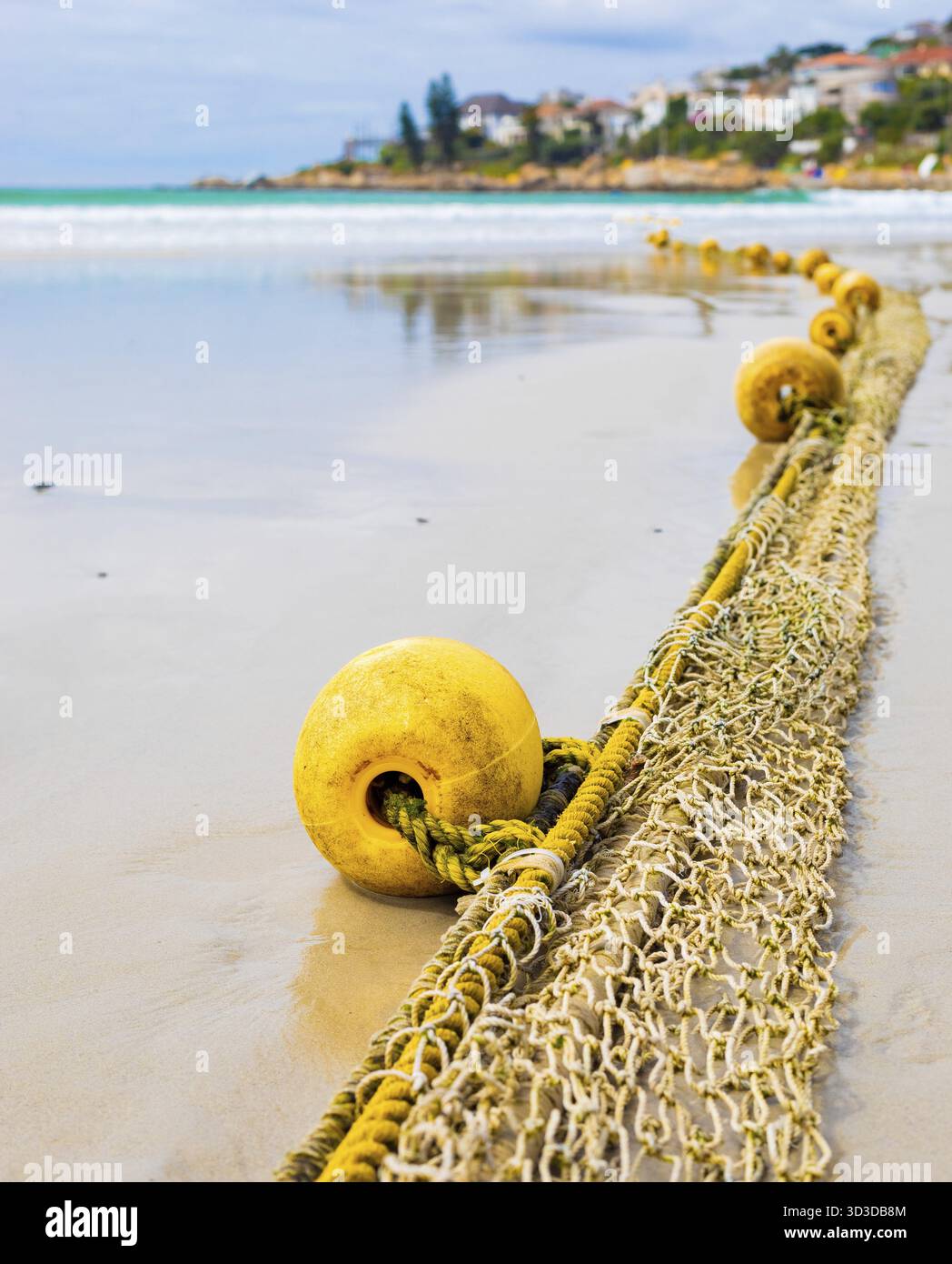 Close-up view of a float of a traditional fishing net on a sandy beach ...