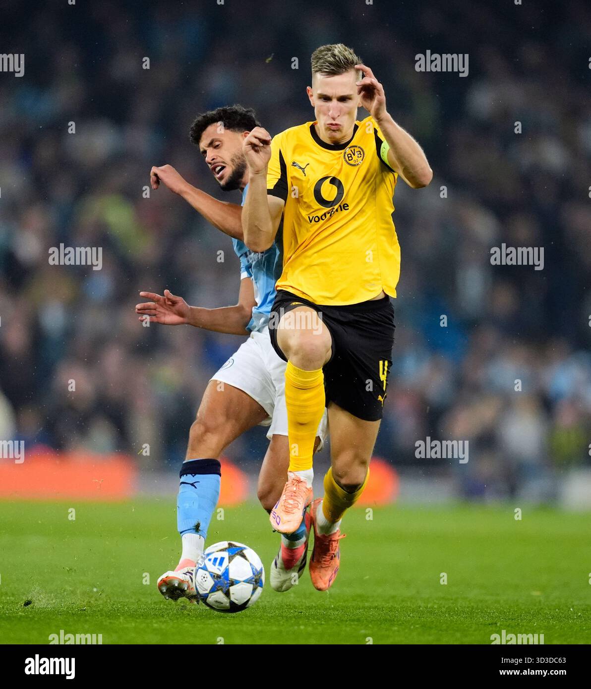 Manchester City's Matheus Nunes and Borussia Dortmund's Nico Schlotterbeck battle for the ball ...