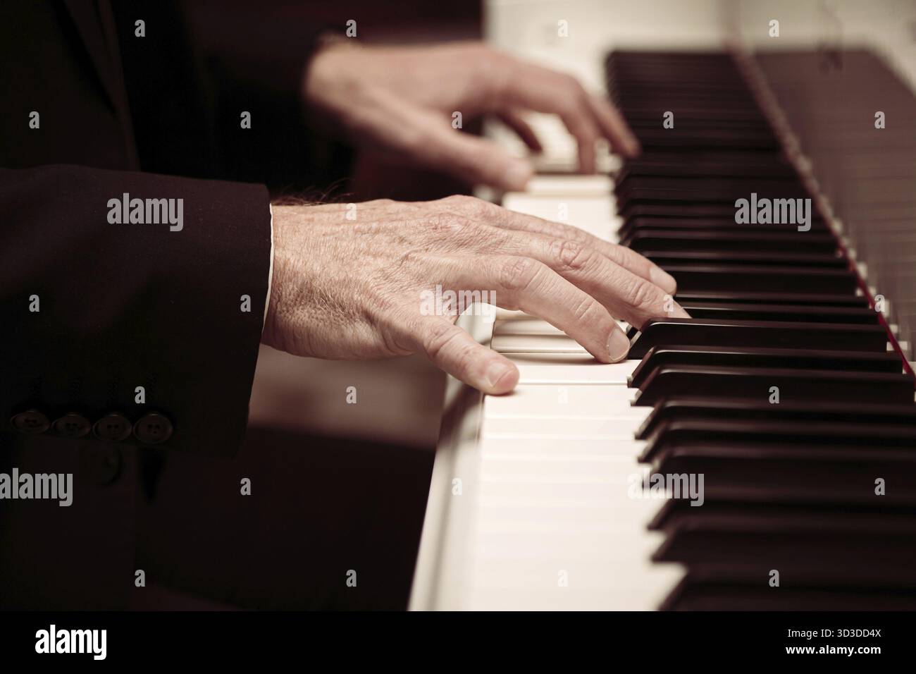 Close up side view of a Caucasian male playing a grand piano Stock ...