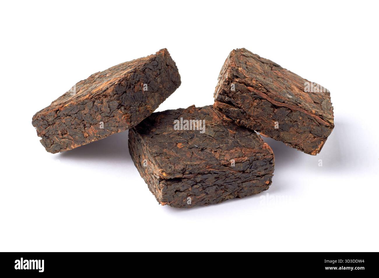 Three pieces of pressed fermented black tea isolated on white ...