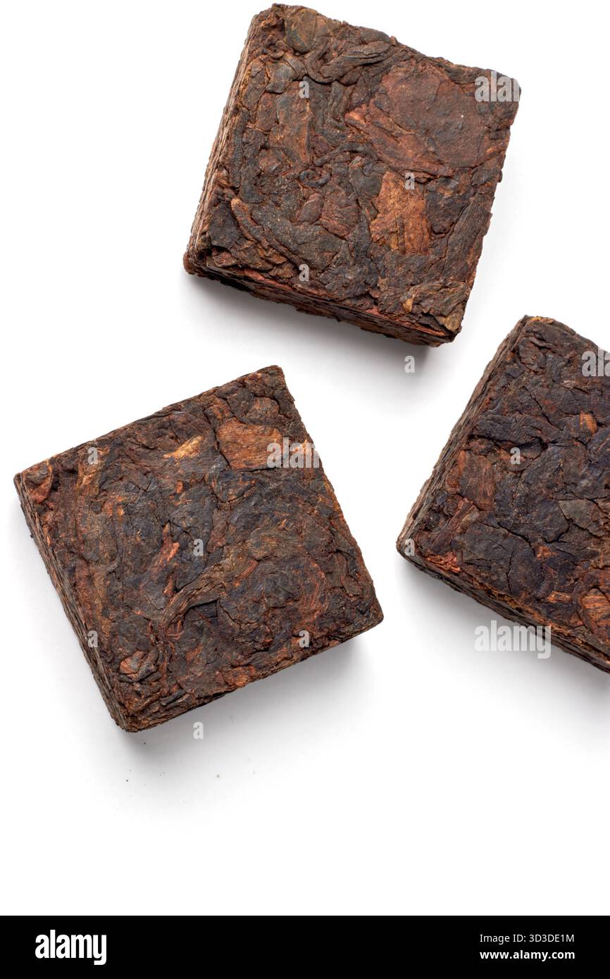 Black pu-erh Chinese tea. Pressed tiles of fermented black tea isolated ...