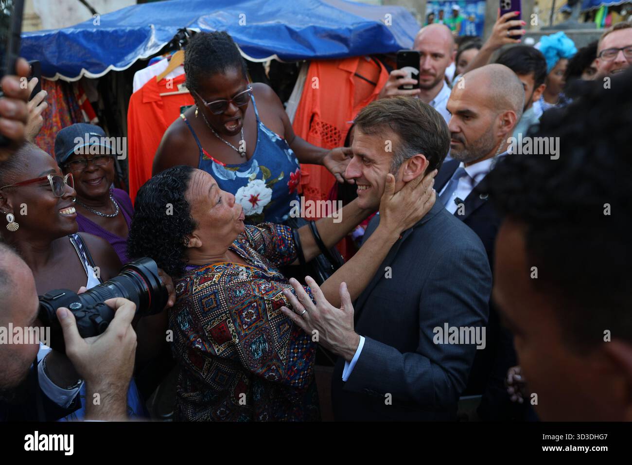 France President Emmanuel Macron greets a woman during a visit to the ...