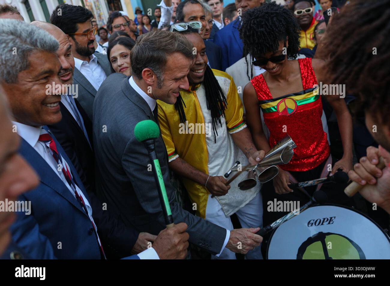 France's President Emmanuel Macron plays a drum during a visit to the ...