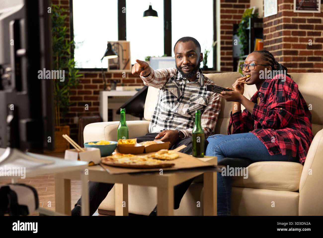 Woman switches television channels relaxing hi-res stock photography ...