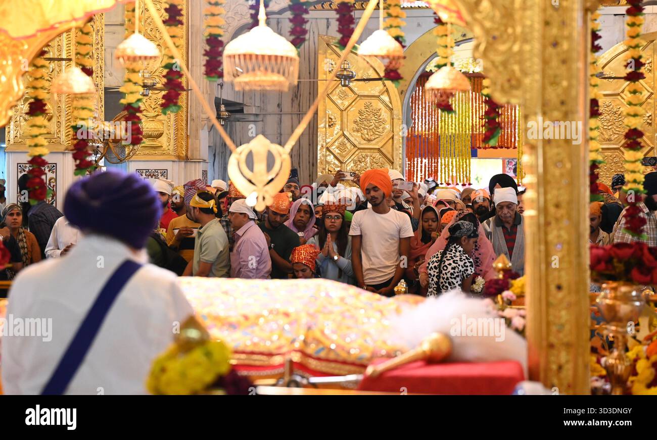 NEW DELHI, INDIA - NOVEMBER 5: Devotees offering prayer at Gurudwara ...