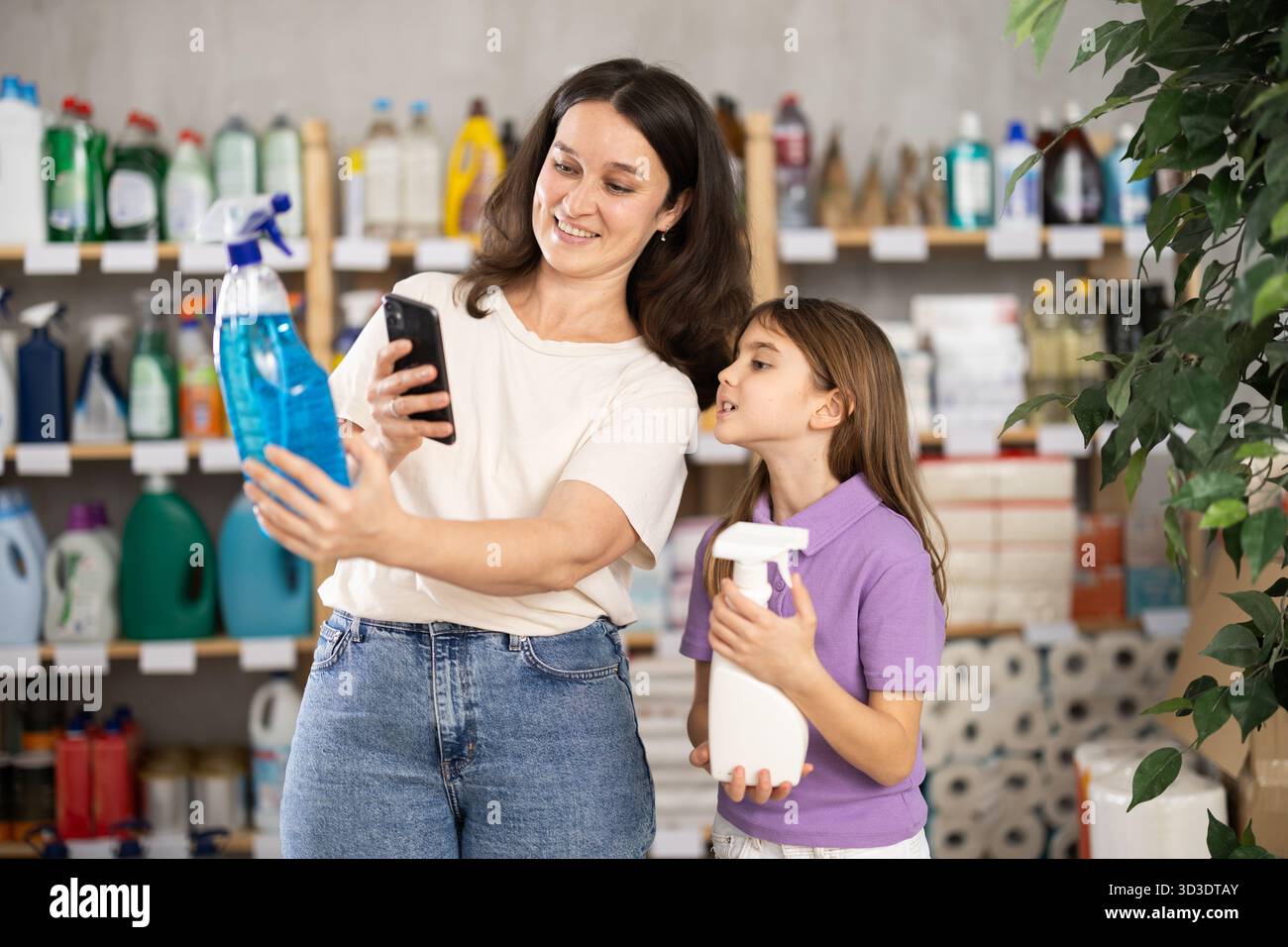 Mom and daughter scanning the barcode on the spray package Stock Photo ...