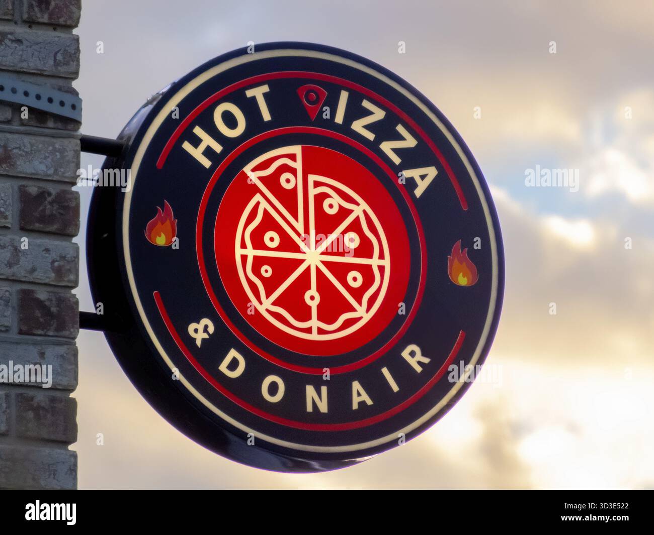 A vibrant sign at storefront, advertising Hot Pizza and Donair. The ...