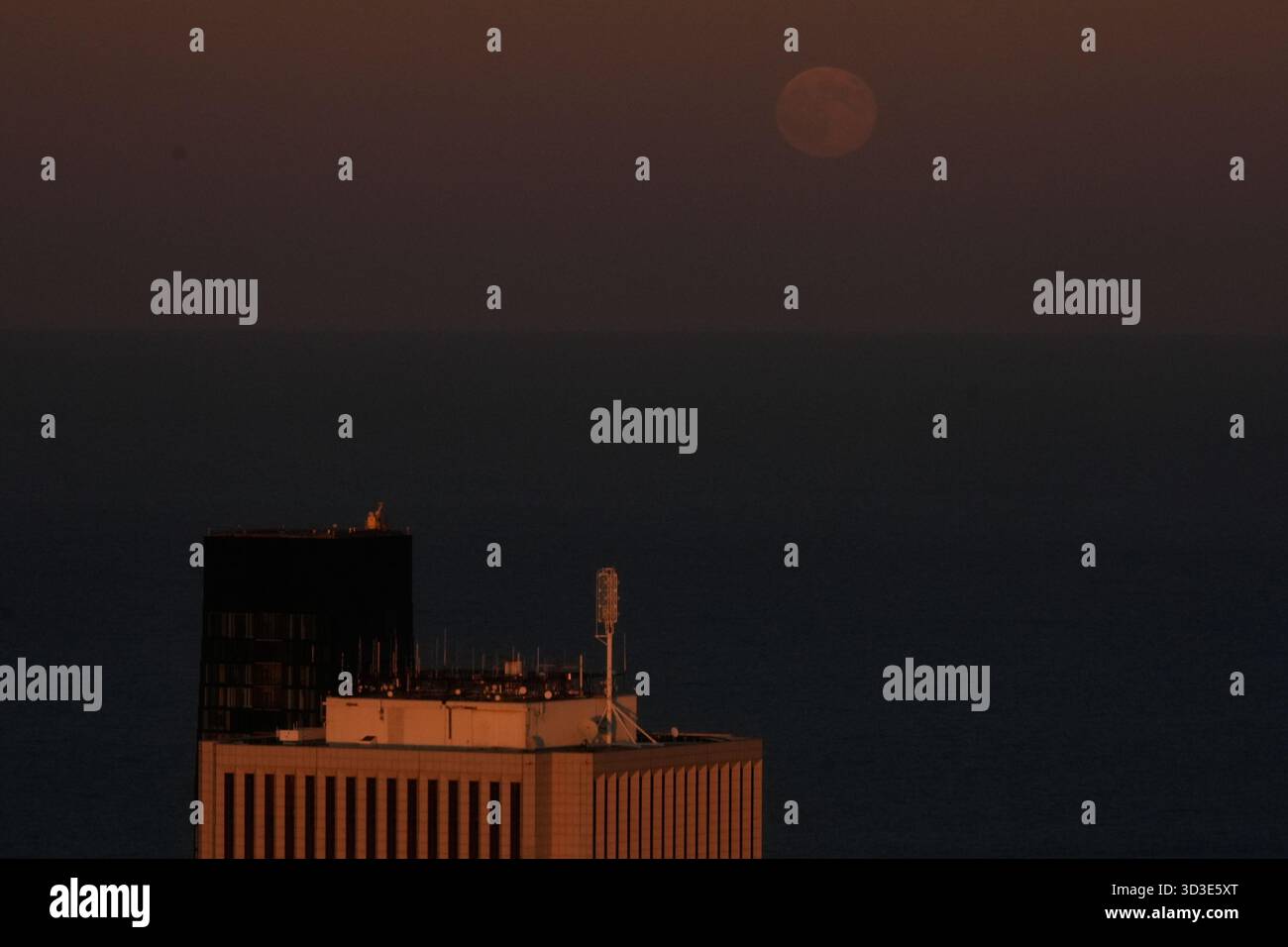 The Beaver Moon, also a supermoon, rises over Lake Michigan and the ...