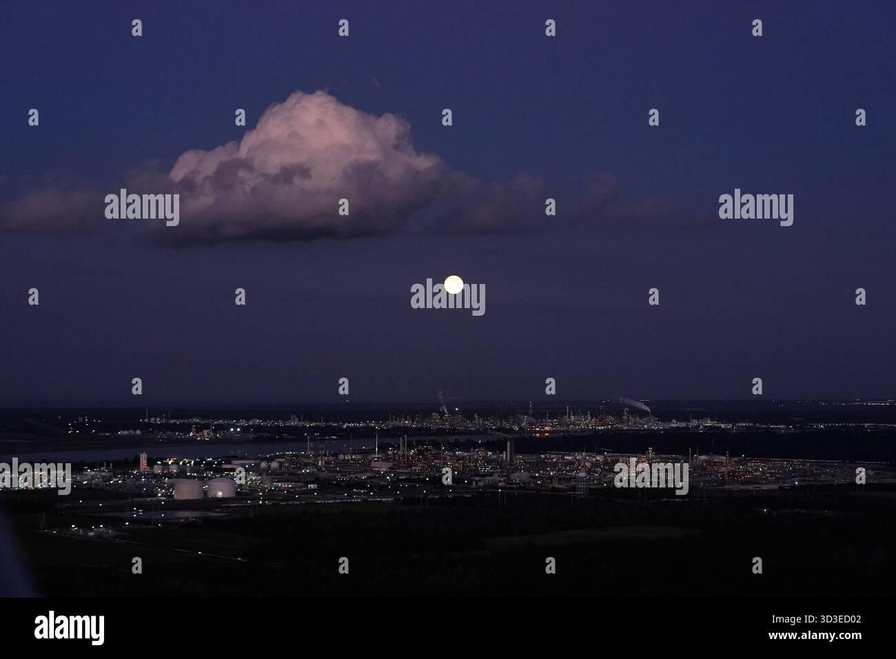 In this aerial photo, a supermoon rises above the Dow Chemical Plant ...