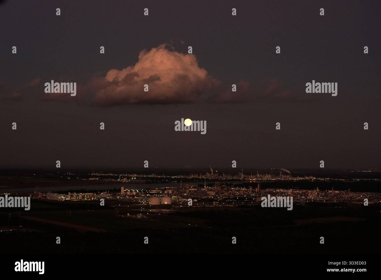 In this aerial photo, a supermoon rises above the Dow Chemical Plant ...