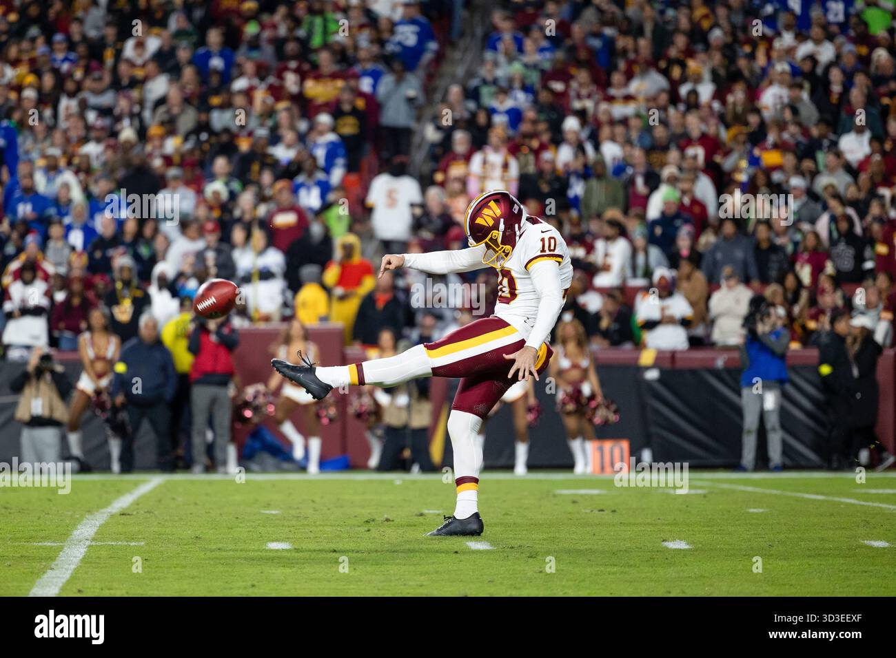Washington Commanders punter Tress Way (10) punts the ball during an ...