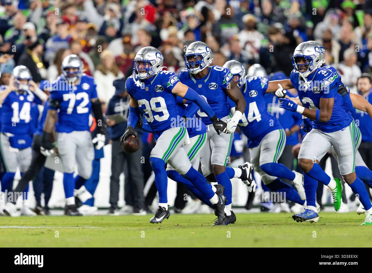 Seattle Seahawks safety Ty Okada (39) runs with the intercepted ball to ...