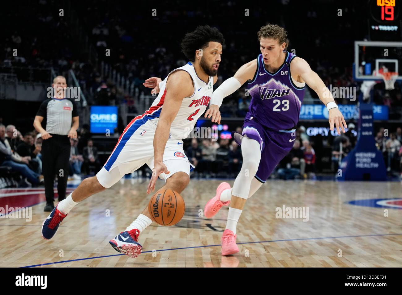 Detroit Pistons guard Cade Cunningham, left, drives against Utah Jazz forward Lauri Markkanen ...