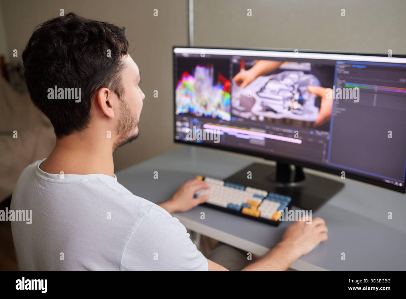back view of young man in the dark studio color grading video with ...