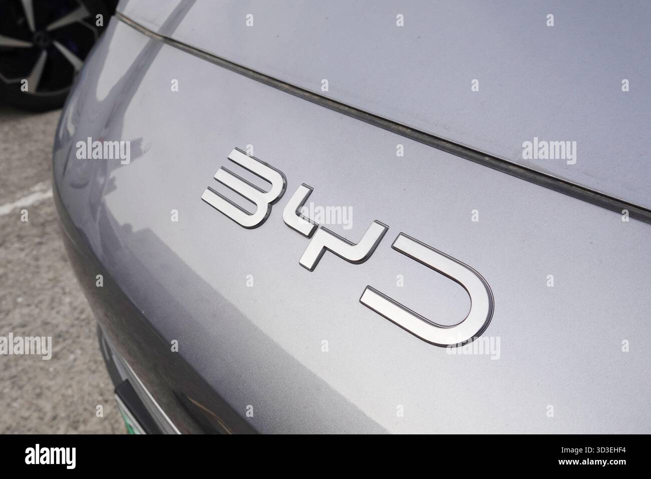 The BYD logo is visible on the body of a gray car Stock Photo - Alamy