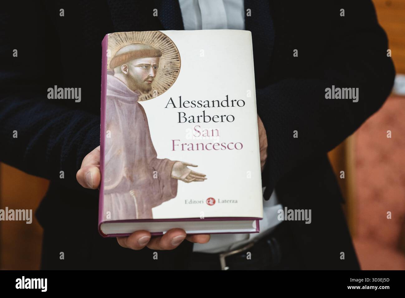 A fan shows the Barbero new book “S. Francesco” in the foyer during the ...