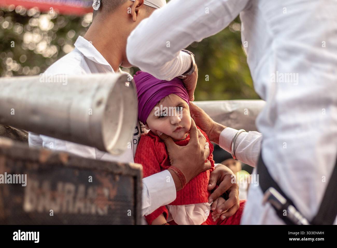 A Sikh child gets his turban tied during a turban seva (selfless ...