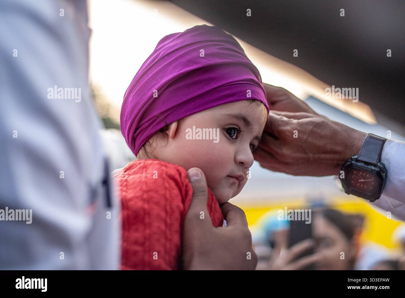 A Sikh child gets his turban tied during a turban seva (selfless ...