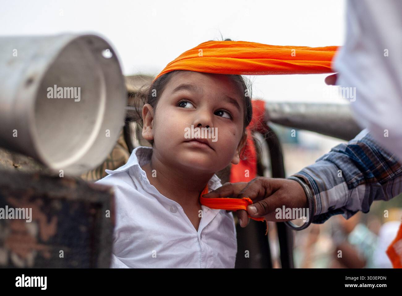 A Sikh child gets his turban tied during a turban seva (selfless ...