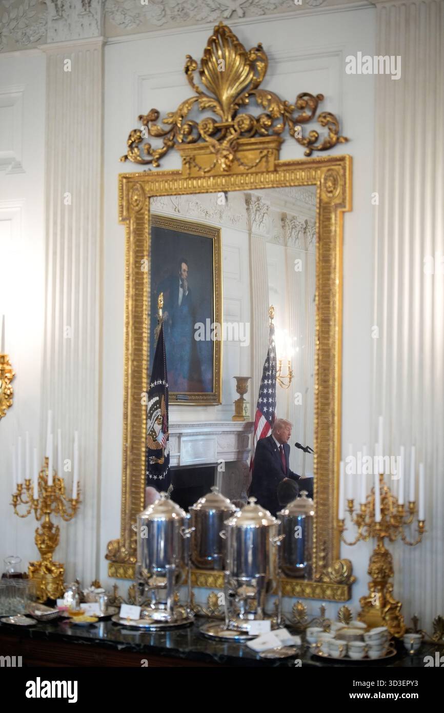 United States President Donald J Trump is reflected in a mirror as he ...