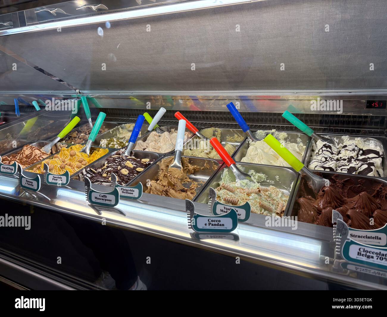 Gelato flavors in a refrigerated display case at Gelateria Gondola in ...