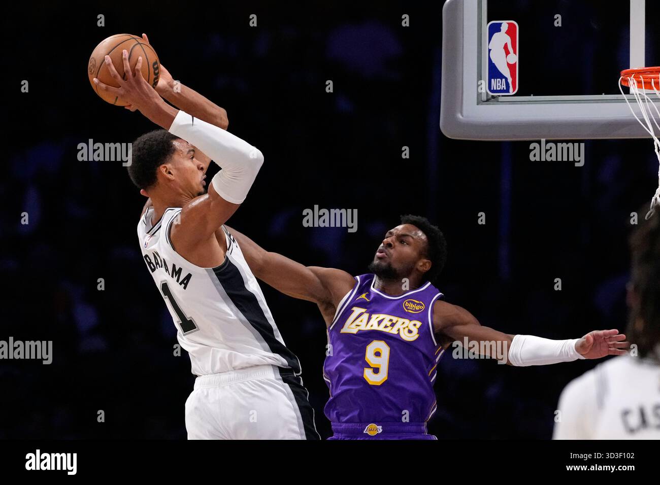 San Antonio Spurs forward Victor Wembanyama, left, goes up fora dunk as ...