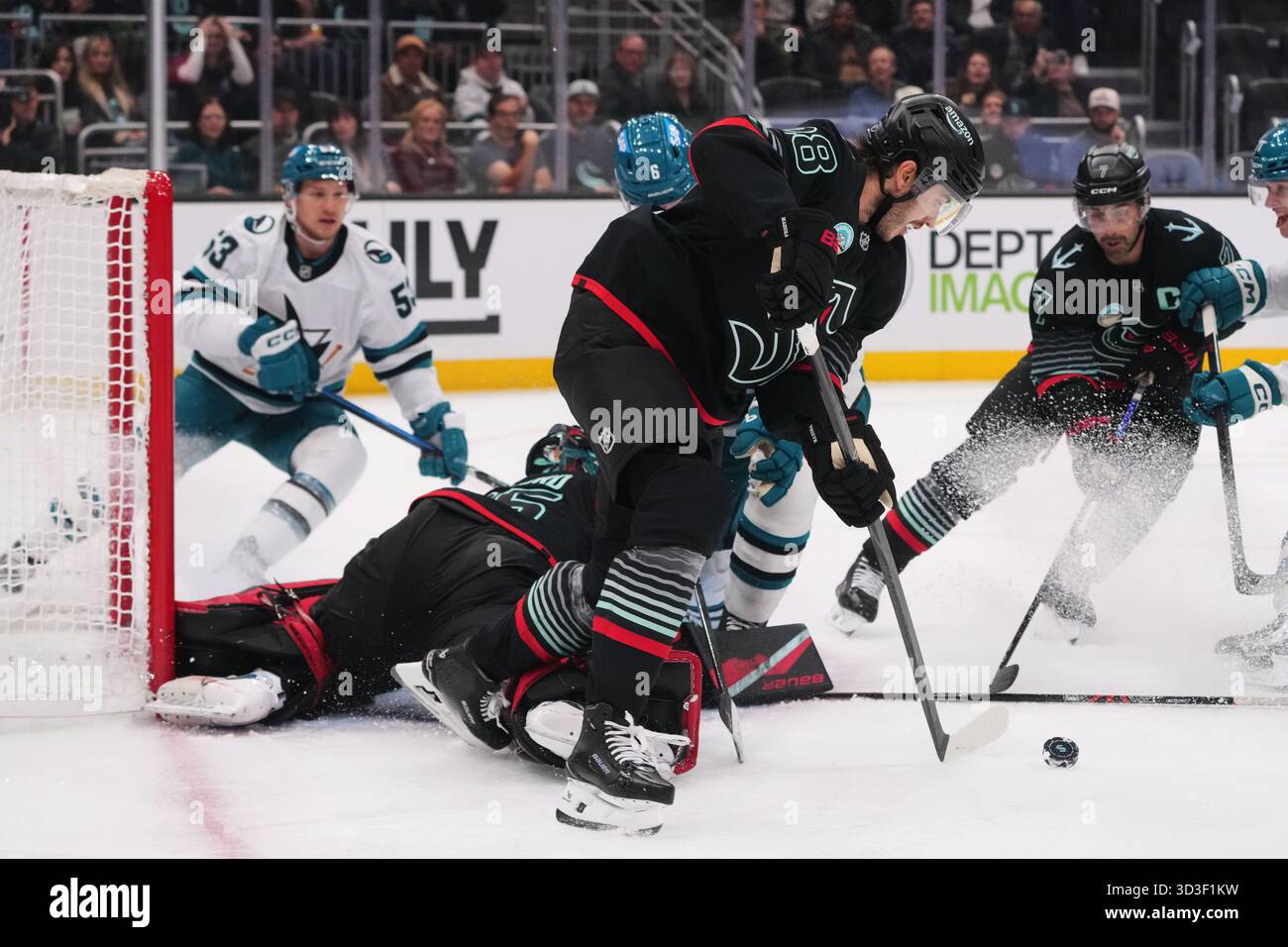 Seattle Kraken defenseman Joshua Mahura (28) clears a puck near the ...