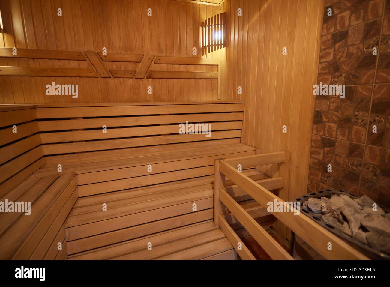 A hardwood sauna with a plank ceiling, brick wall, and stairs Stock ...