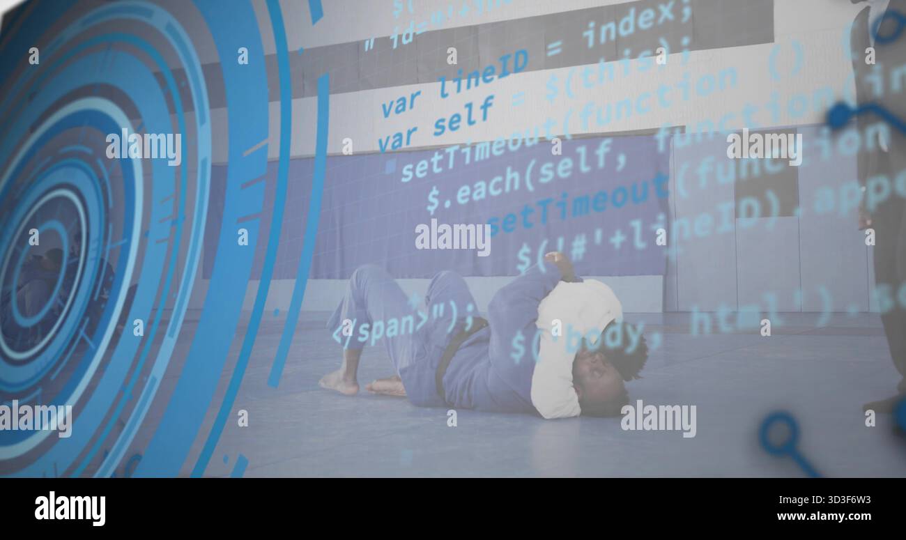 Martial artists practicing grappling in white-and-blue gi on blue mat ...
