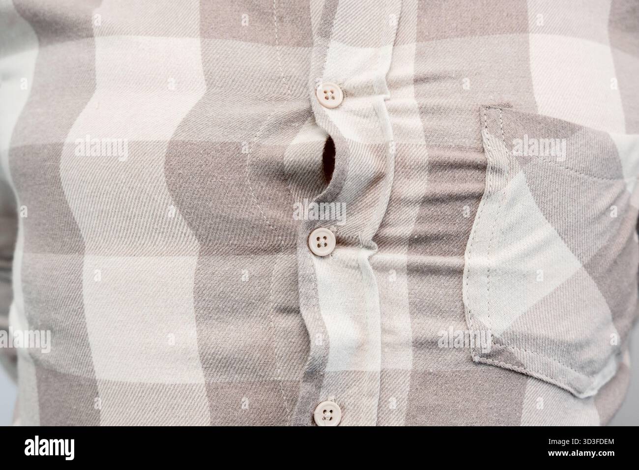 Close-up of a man in a tight shirt, shirt too small, overweight man ...