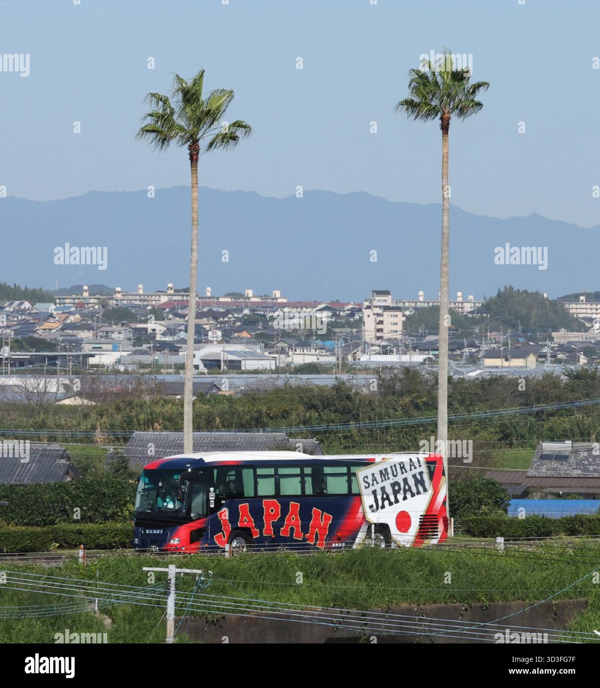 A photo shows a Samurai Japan-themed wrapped bus running through ...