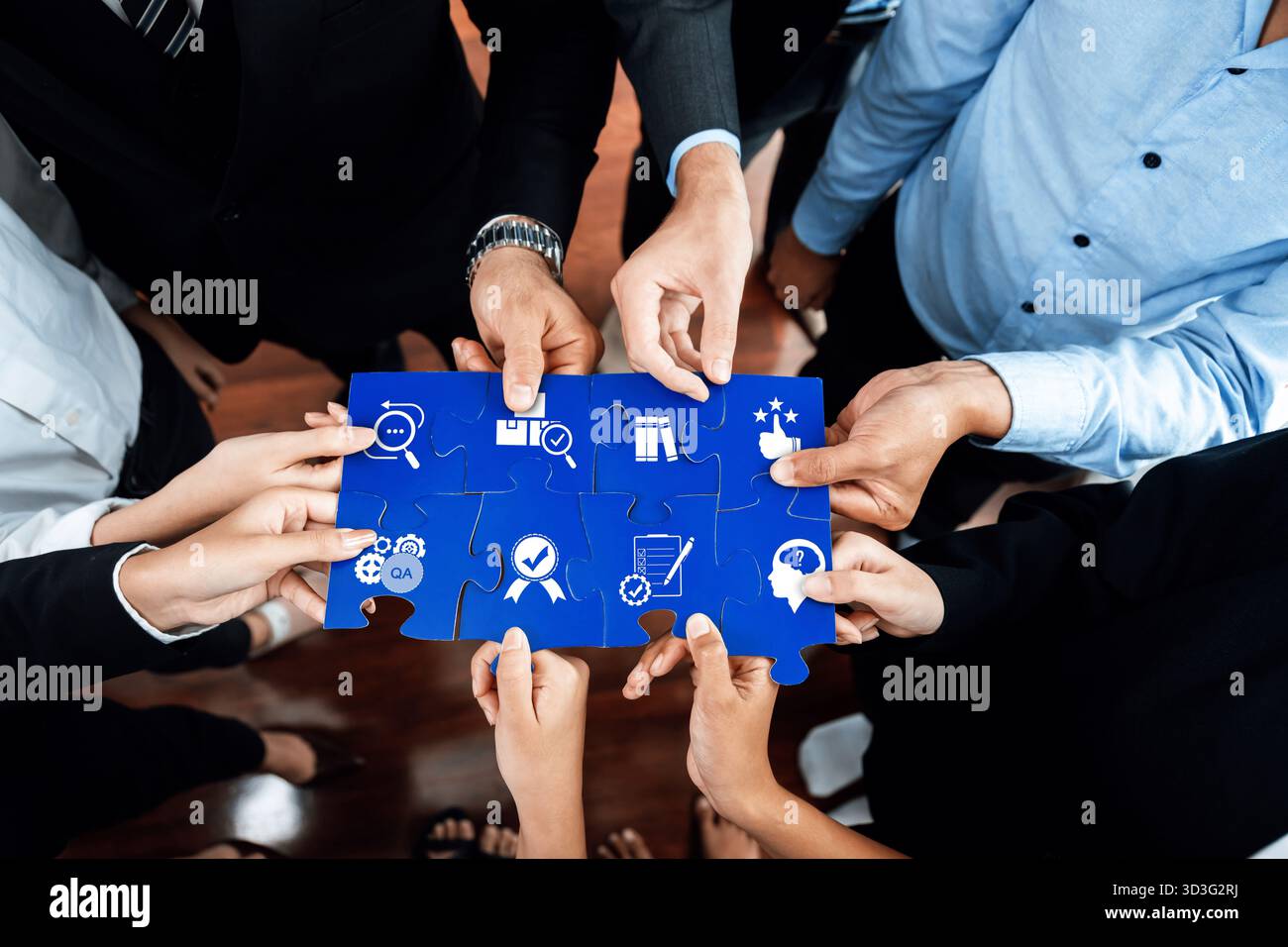 A diverse group working together to complete a puzzle, symbolizing ...
