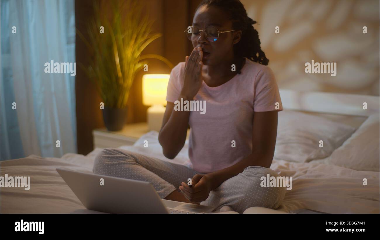 Tired african student yawning reading hi-res stock photography and ...