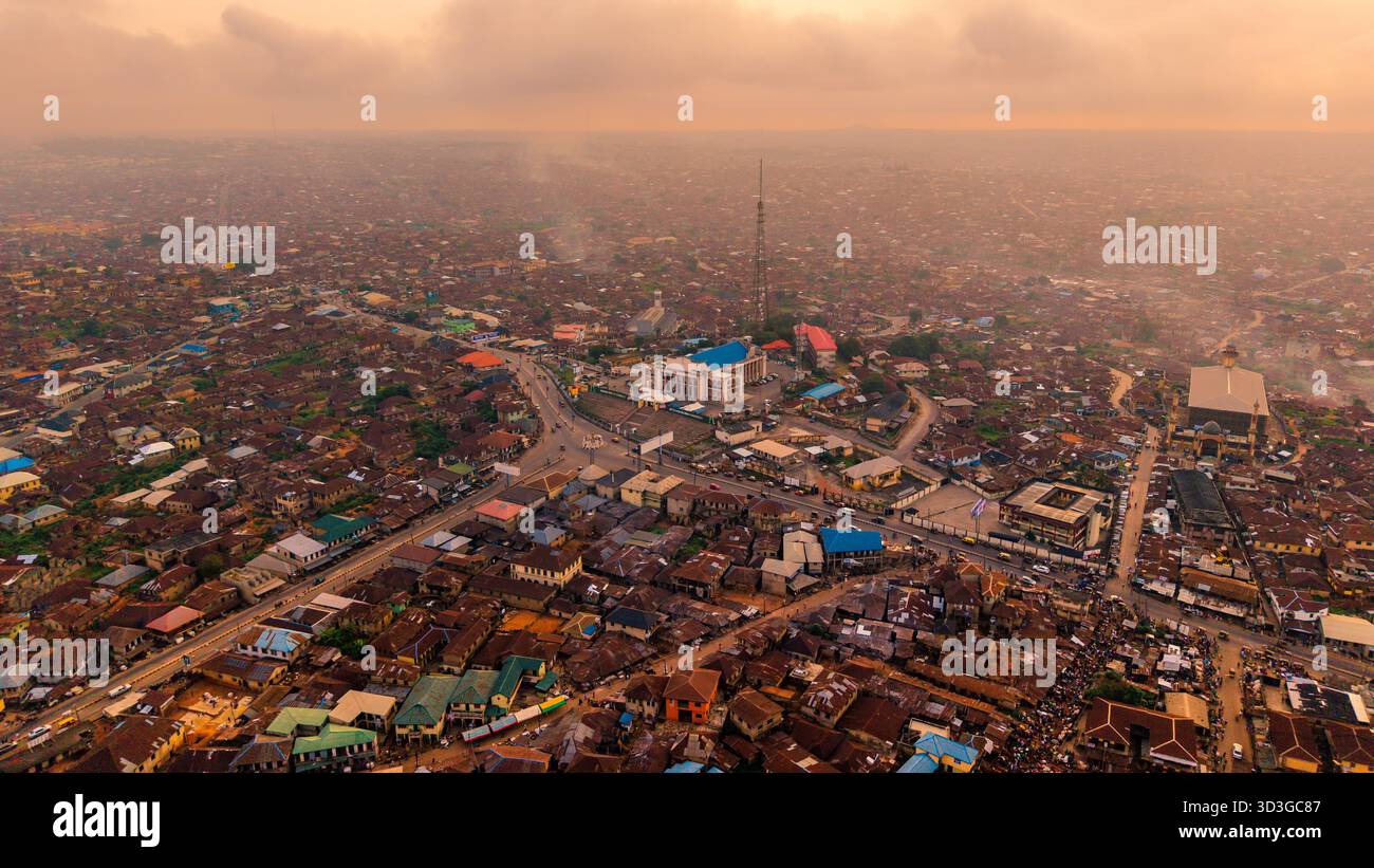 Aerial view of the city's heart, where buildings cluster and roads converge under a hazy sky ...