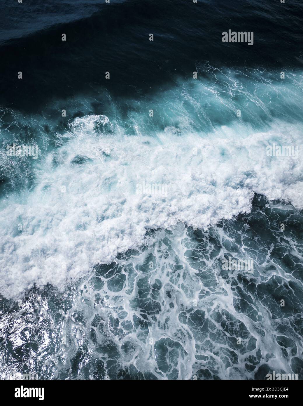 Aerial view of the mesmerizing ocean's turbulent embrace, where deep ...
