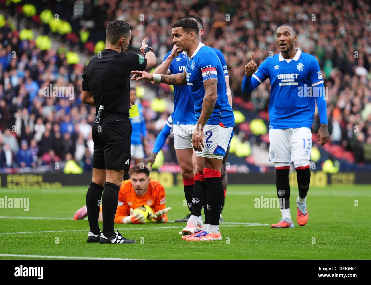 Referee Nick Walsh speaking with James Tavernier after Celtic's Auston ...