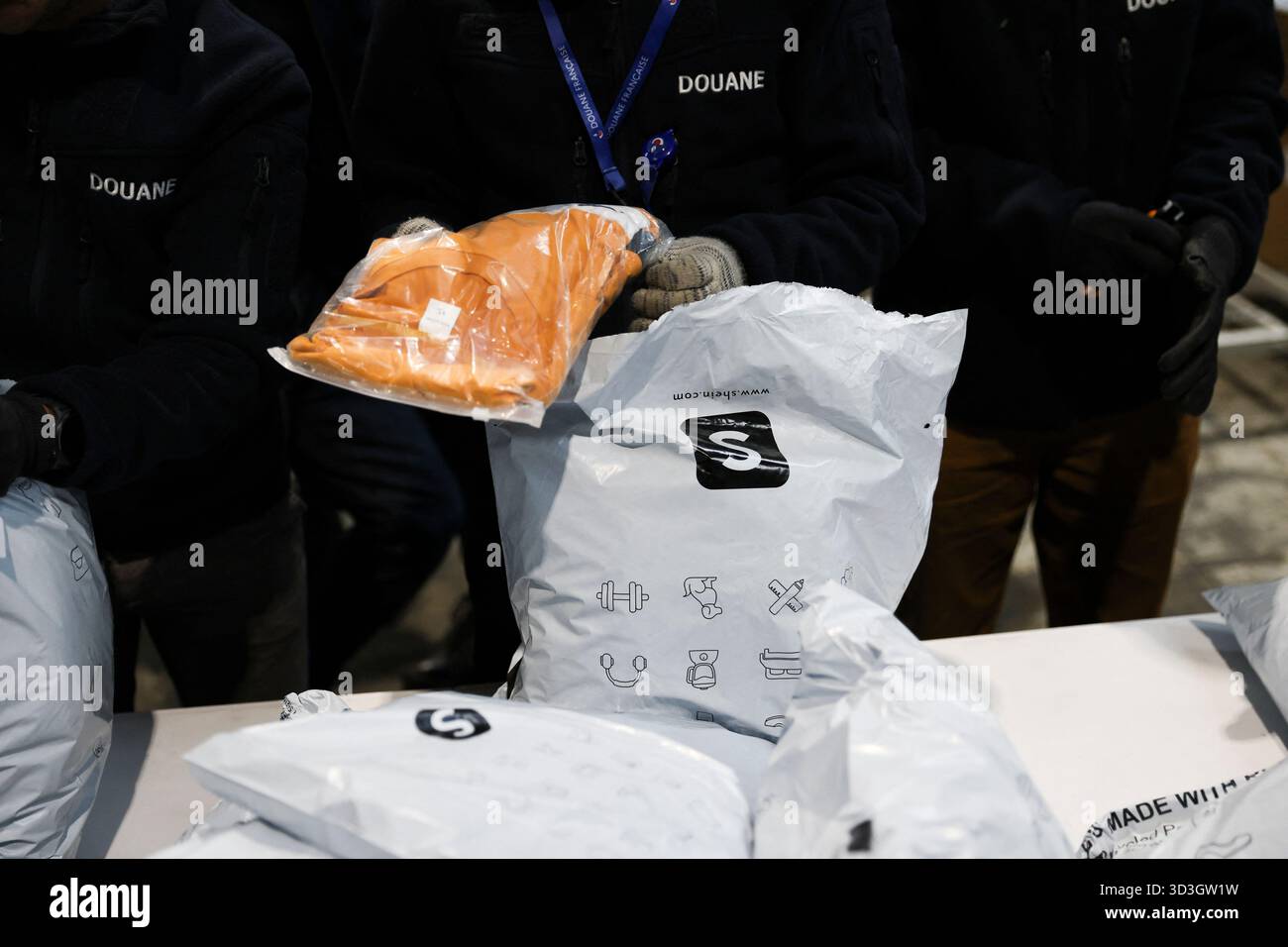 Customs agents inspect packages containing Shein brand cosmetics during ...