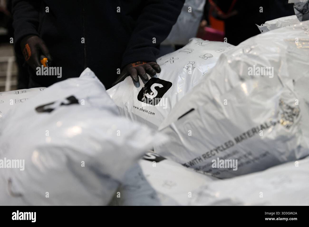 Customs agents inspect packages containing Shein brand cosmetics during ...