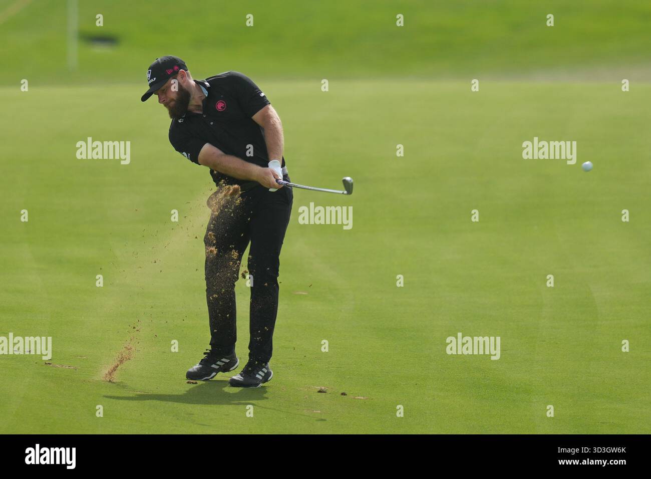 Tyrell Hatton of England plays his second shot on the 17th hole during ...