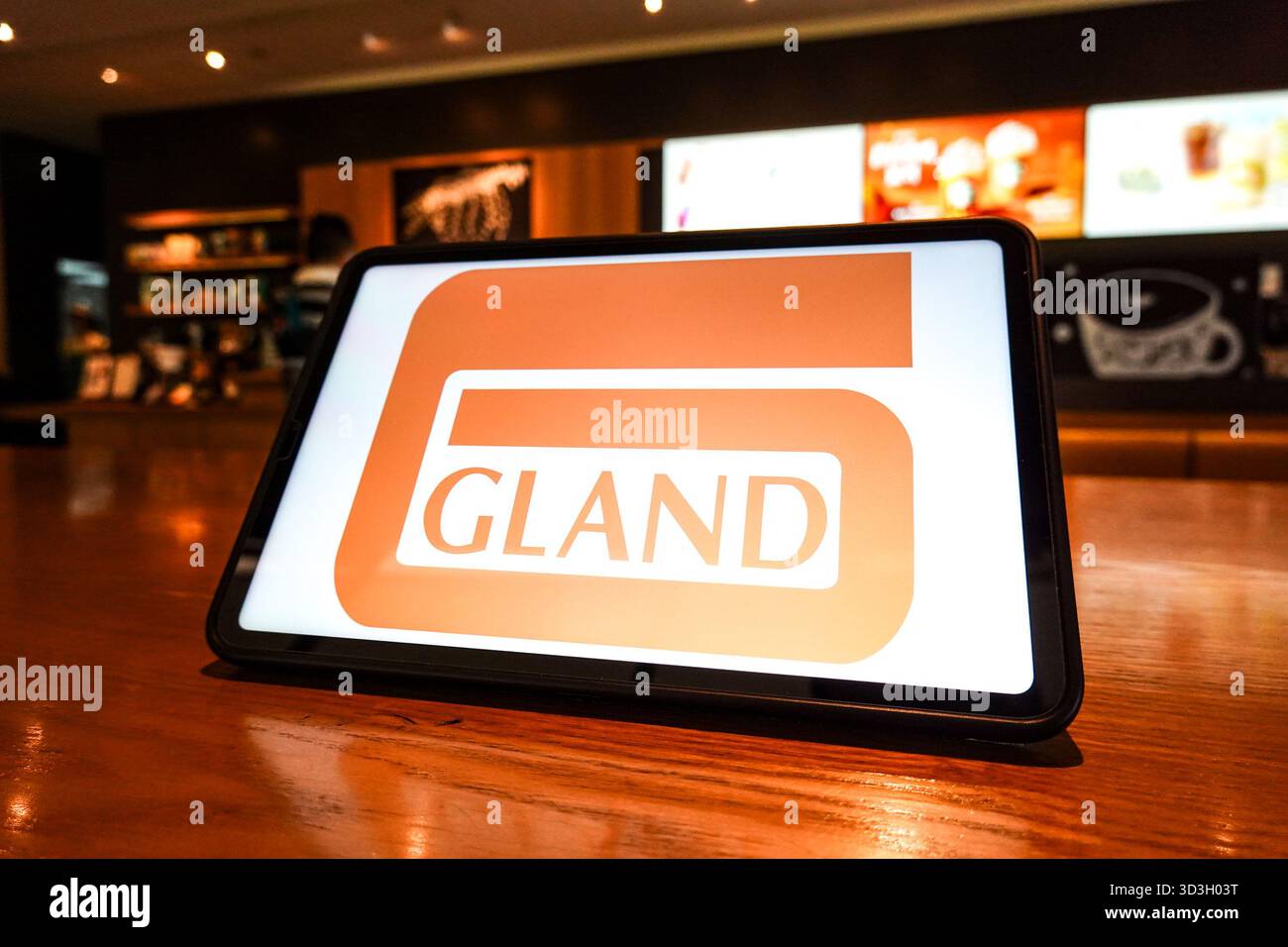 In this photo illustration, the Gland logo is displayed on the screen ...