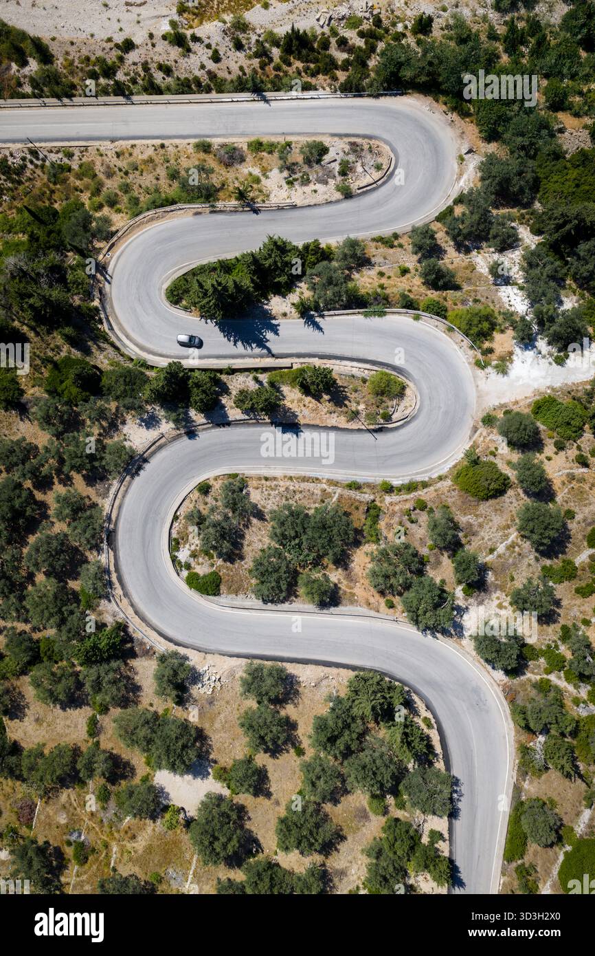 Aerial view of a winding road snaking through the rugged landscape, a ...