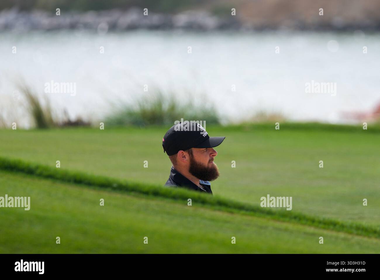 Tyrell Hatton of England prepares to hit a shot from a bunker on the ...